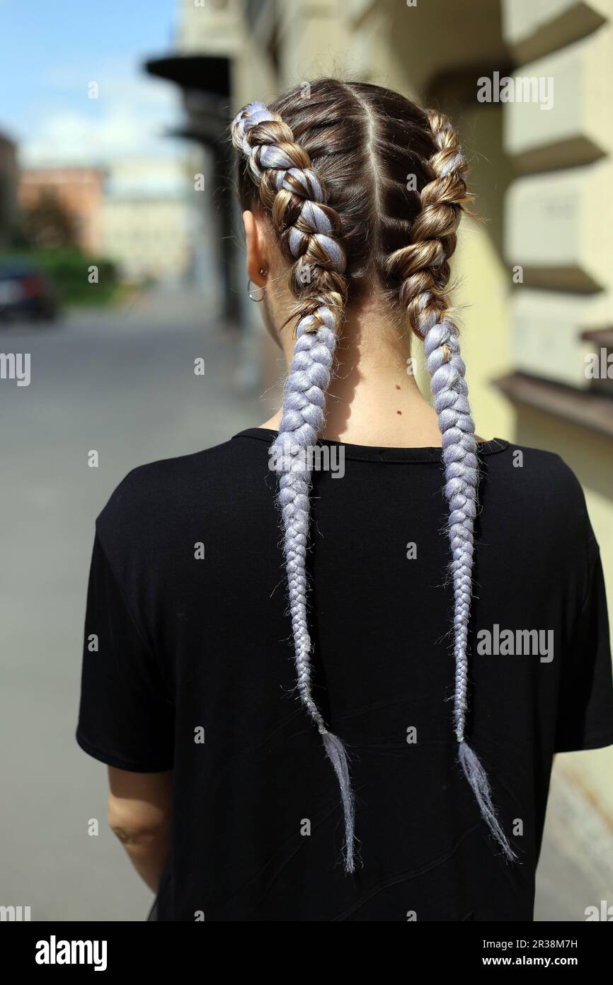 Two braids against the backdrop of the city, a hairstyle from th Stock ...