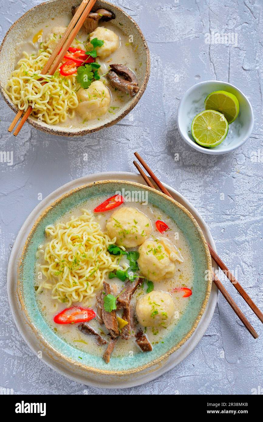 Thai soup with chow mein noodles fish pulp and chilli Stock Photo - Alamy