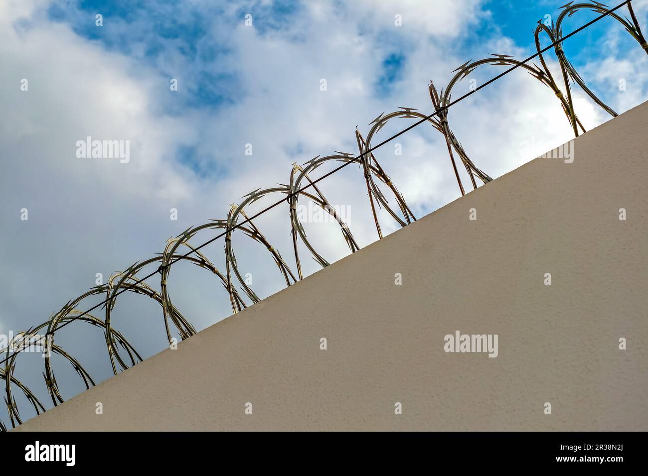 Concrete fence with barbed wire Stock Photo - Alamy