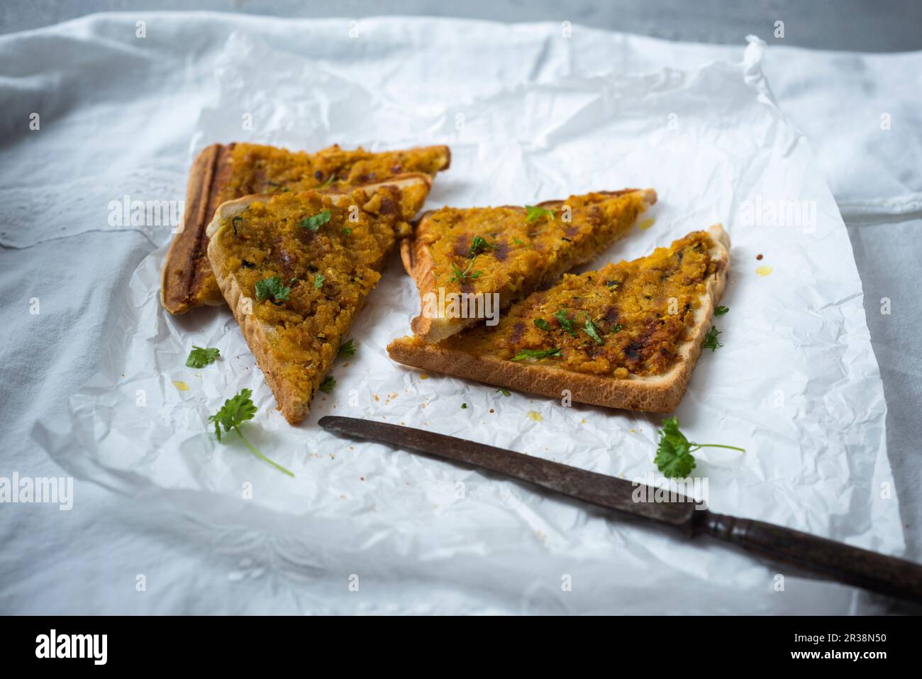 Toast topped with vegan chickpea curry spread Stock Photo - Alamy