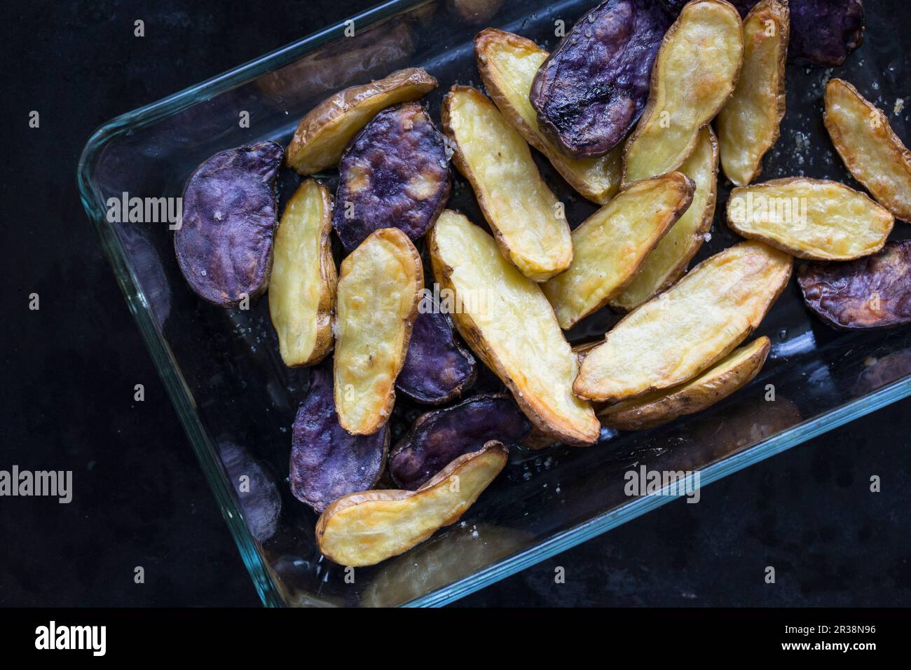 Oven-roasted potatoes in a glass dish Stock Photo - Alamy