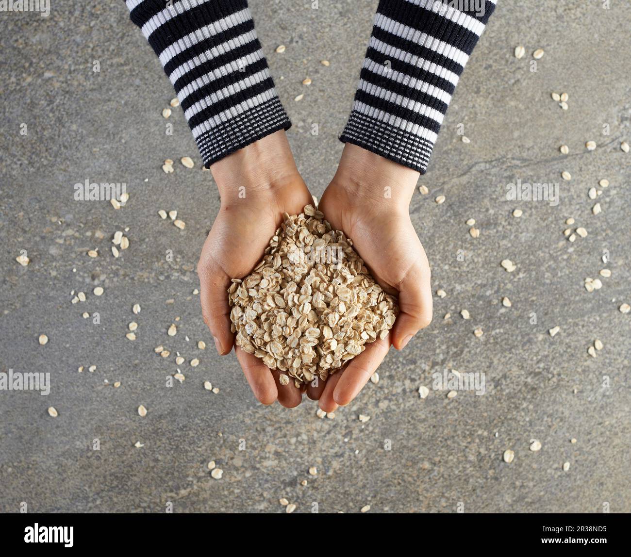 Hands holding rolled oats Stock Photo - Alamy