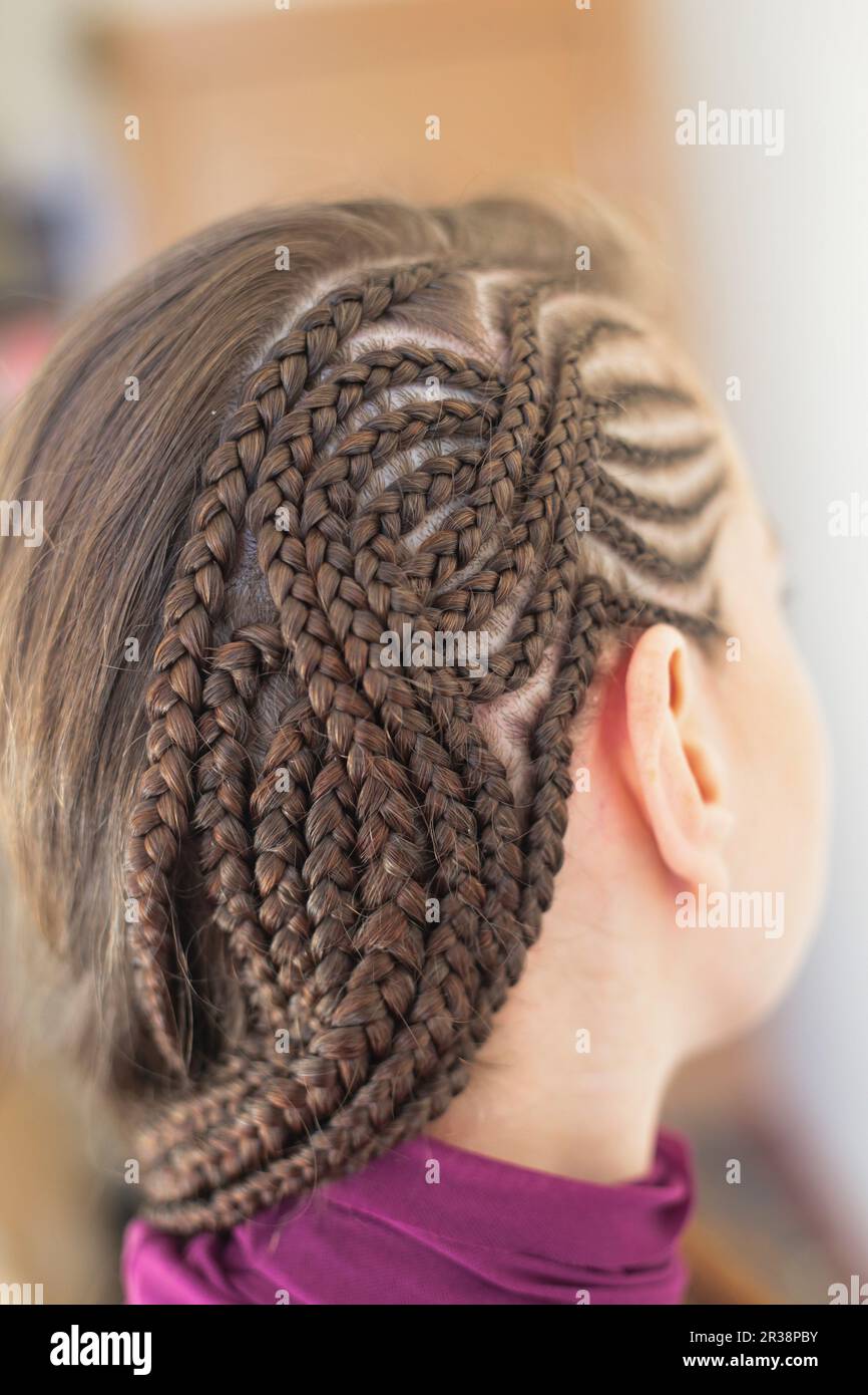 Pattern on the temple, thin braids Stock Photo - Alamy
