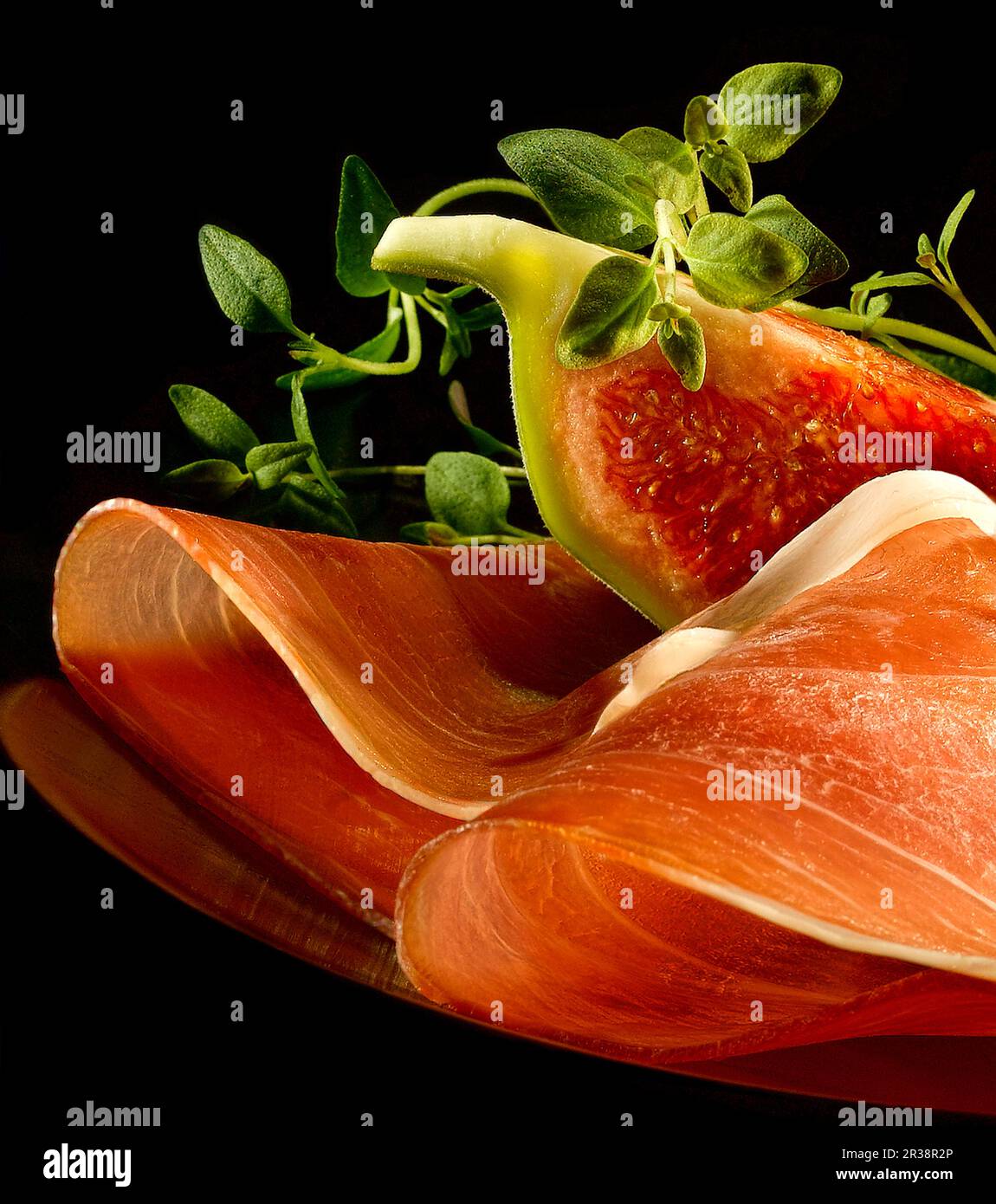 Parma ham and a fresh fig Stock Photo - Alamy