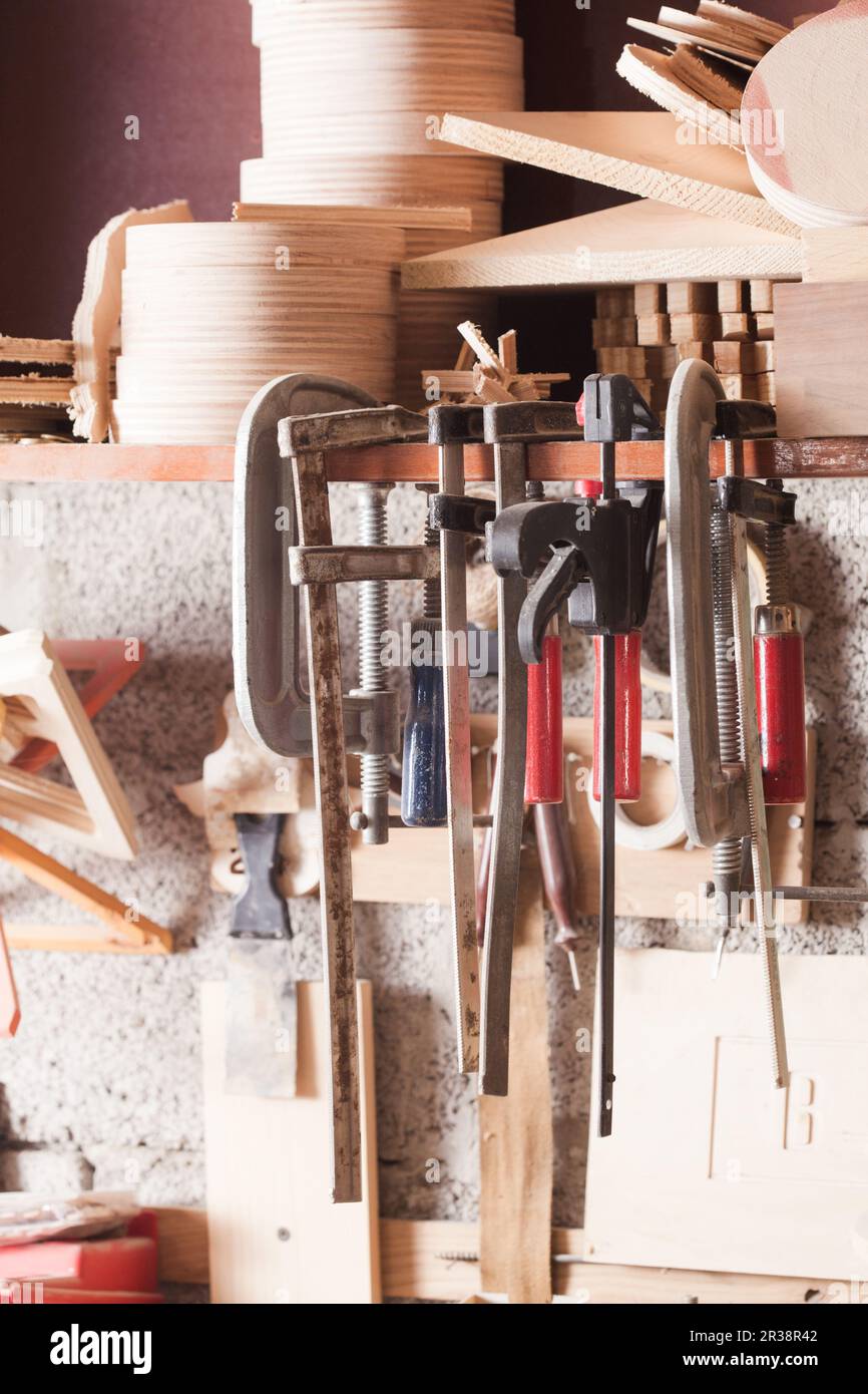 Carpenter tools fixed on the wall at workshop Stock Photo - Alamy