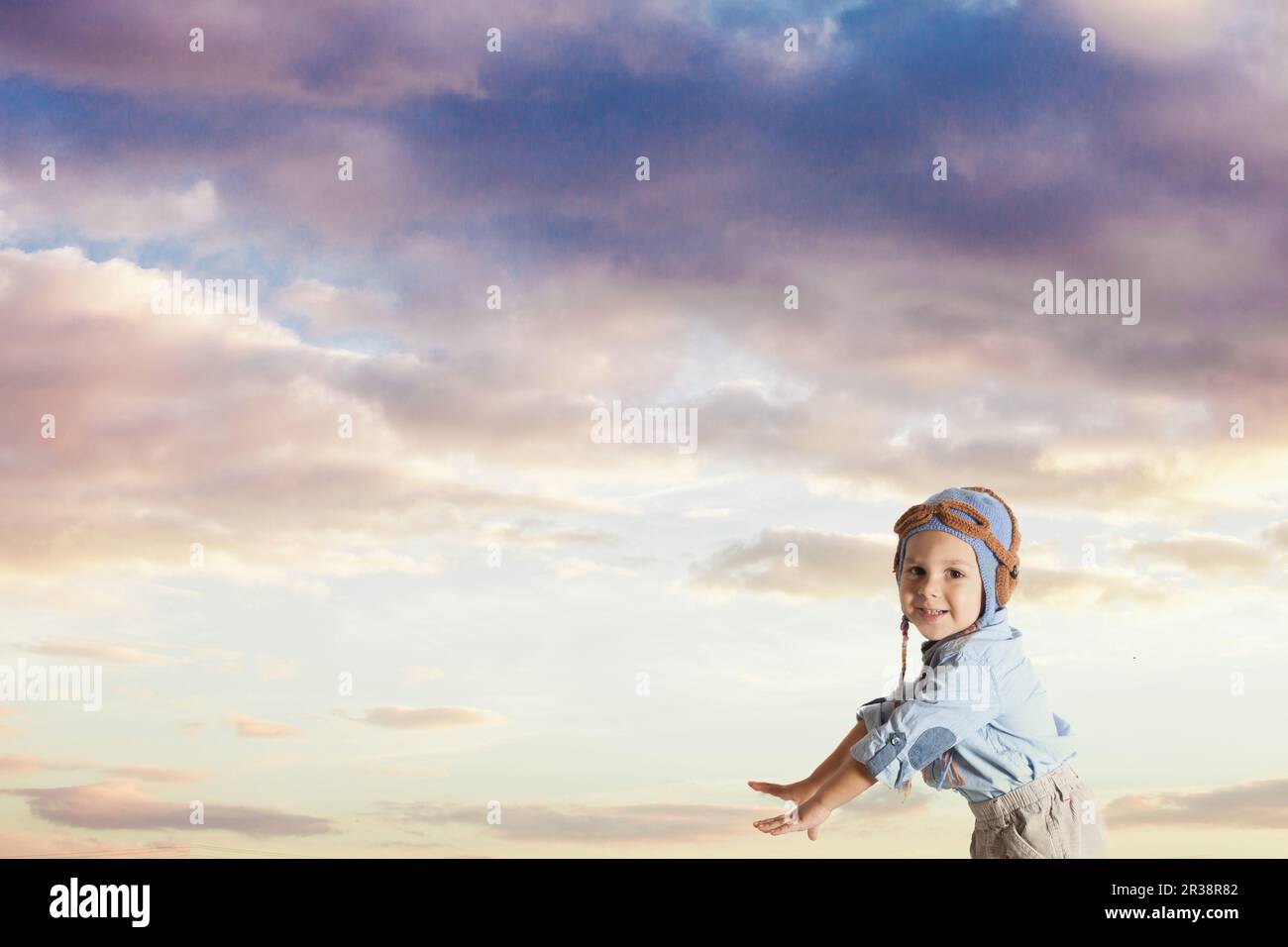 Small boy playing a pilot in knitted helmet Stock Photo - Alamy