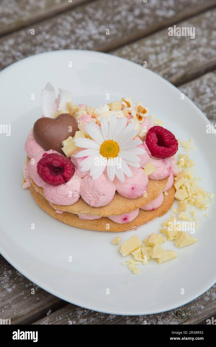 A slice of lavishly decorated flower-shaped cake with raspberry ...