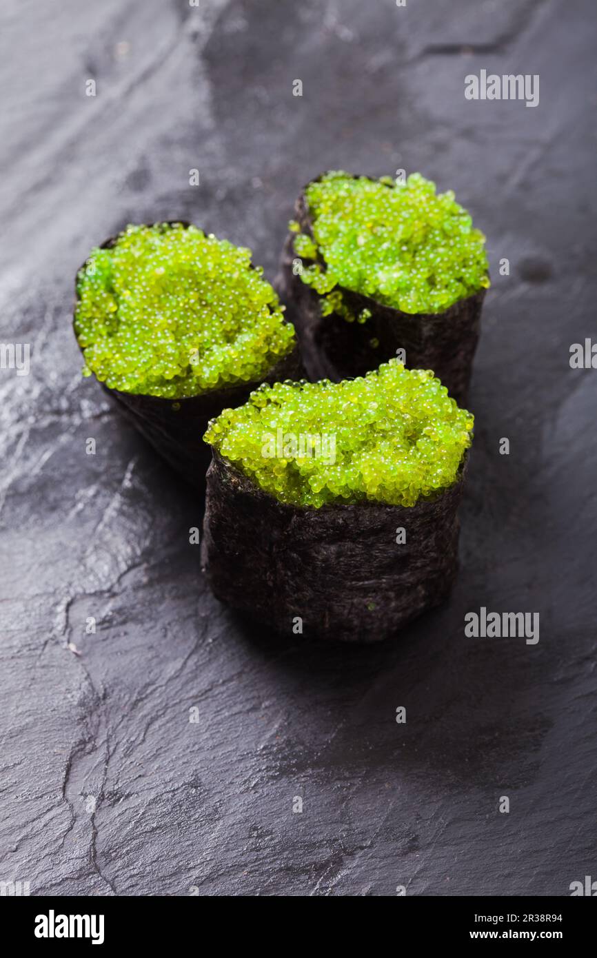 Tobiko green sushi set on the slate background Stock Photo - Alamy