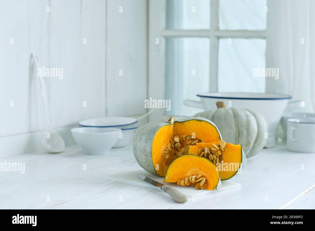 A sliced Crown Prince pumpkin on a kitchen counter Stock Photo - Alamy
