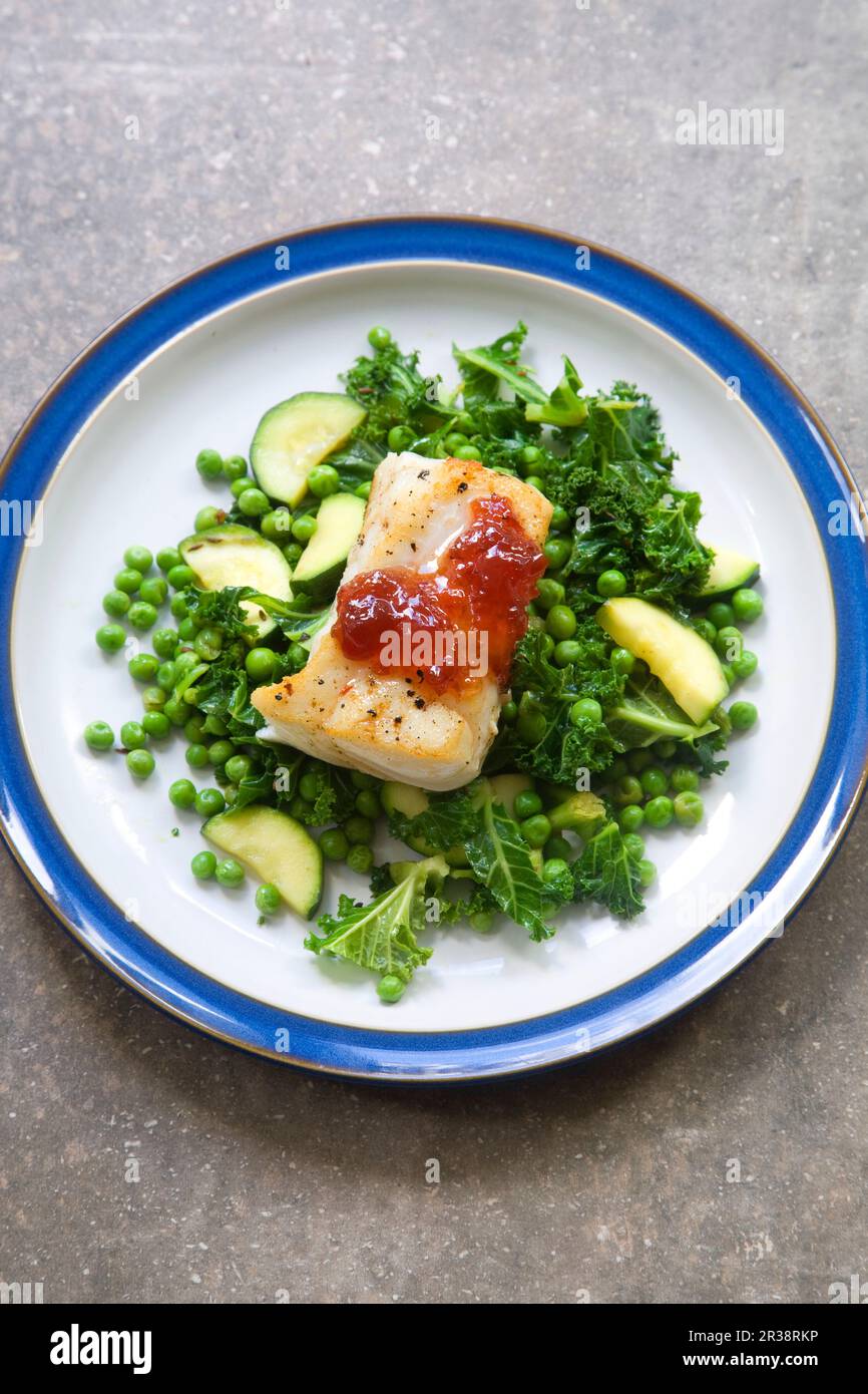 Pan fried cod loin with steamed greens and chilli jam Stock Photo - Alamy