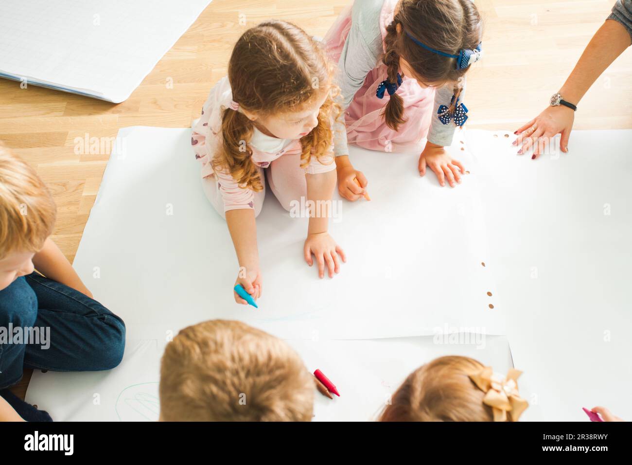Top view of group of kids drawing on a floor Stock Photo - Alamy