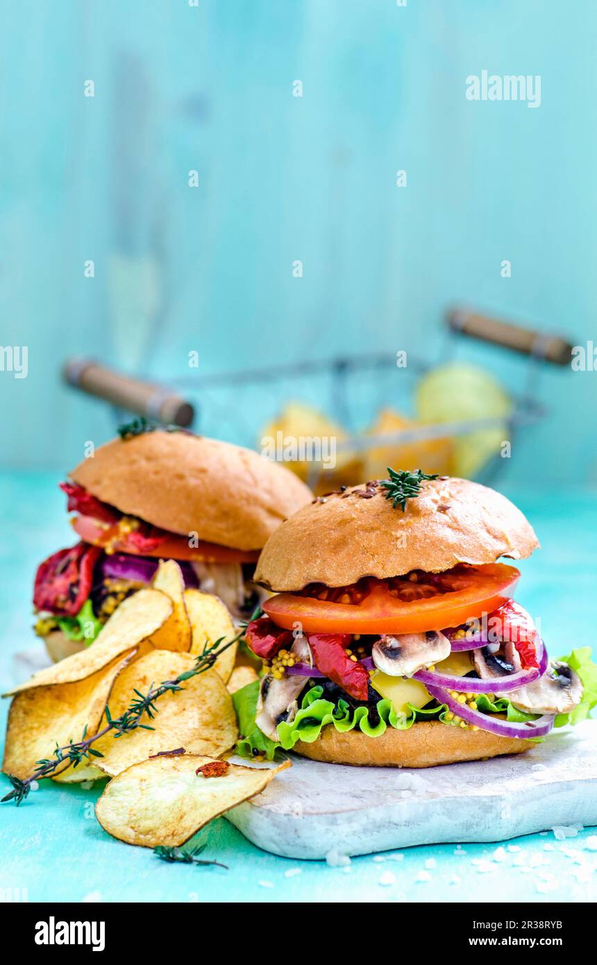 Burgers and potato chips on a blue background Stock Photo - Alamy
