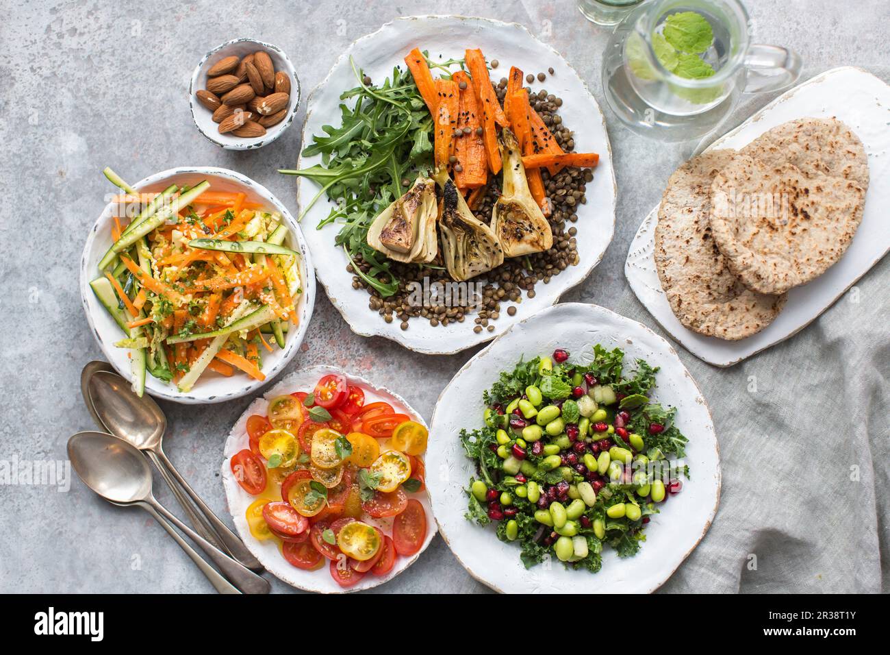 Various vegetable salads with pita bread Stock Photo - Alamy