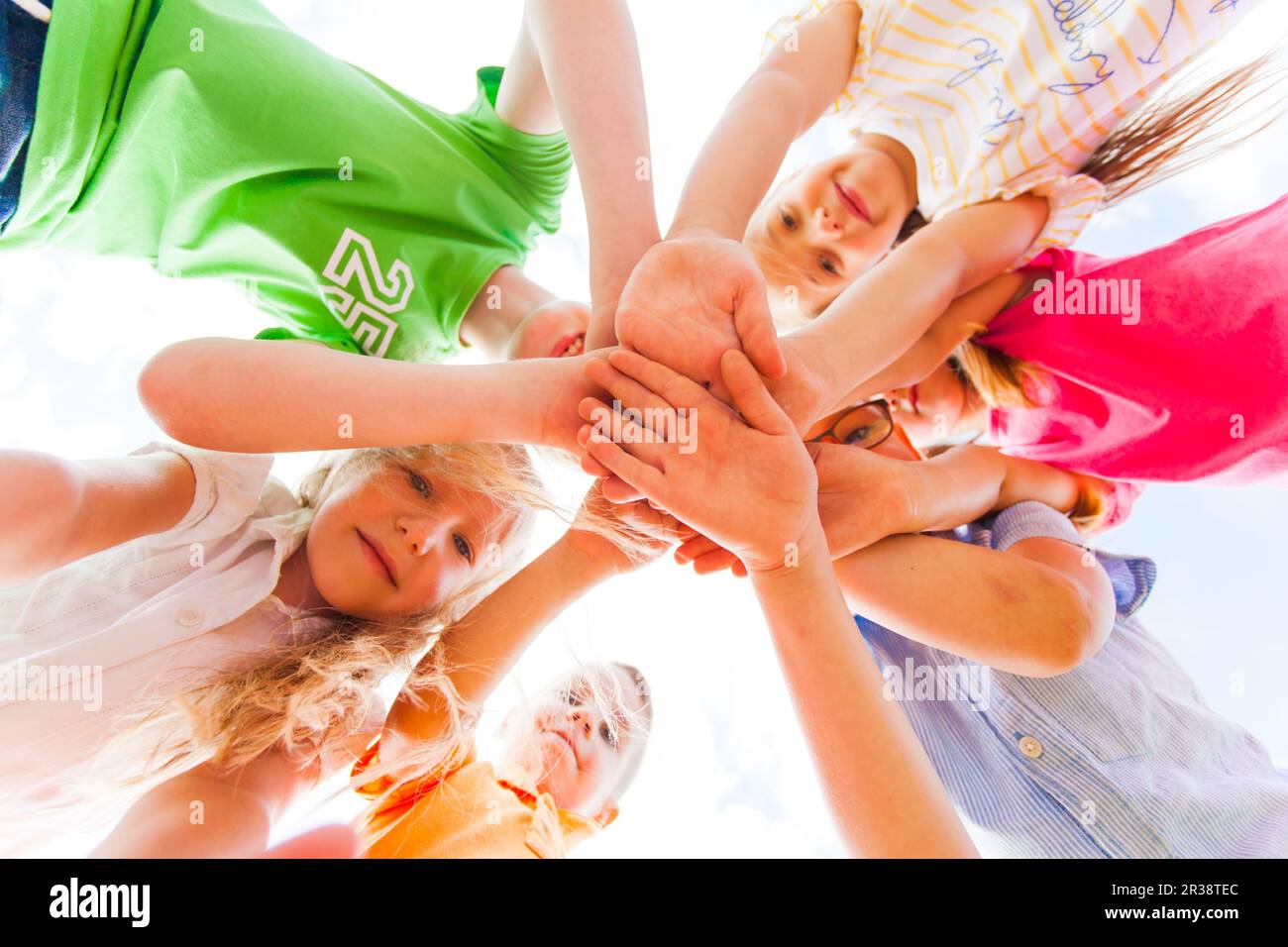 Kids hands together in circle laying one on another Stock Photo - Alamy