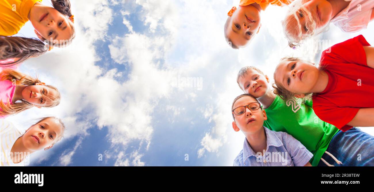 Kids standing leaning looking at the camera Stock Photo - Alamy