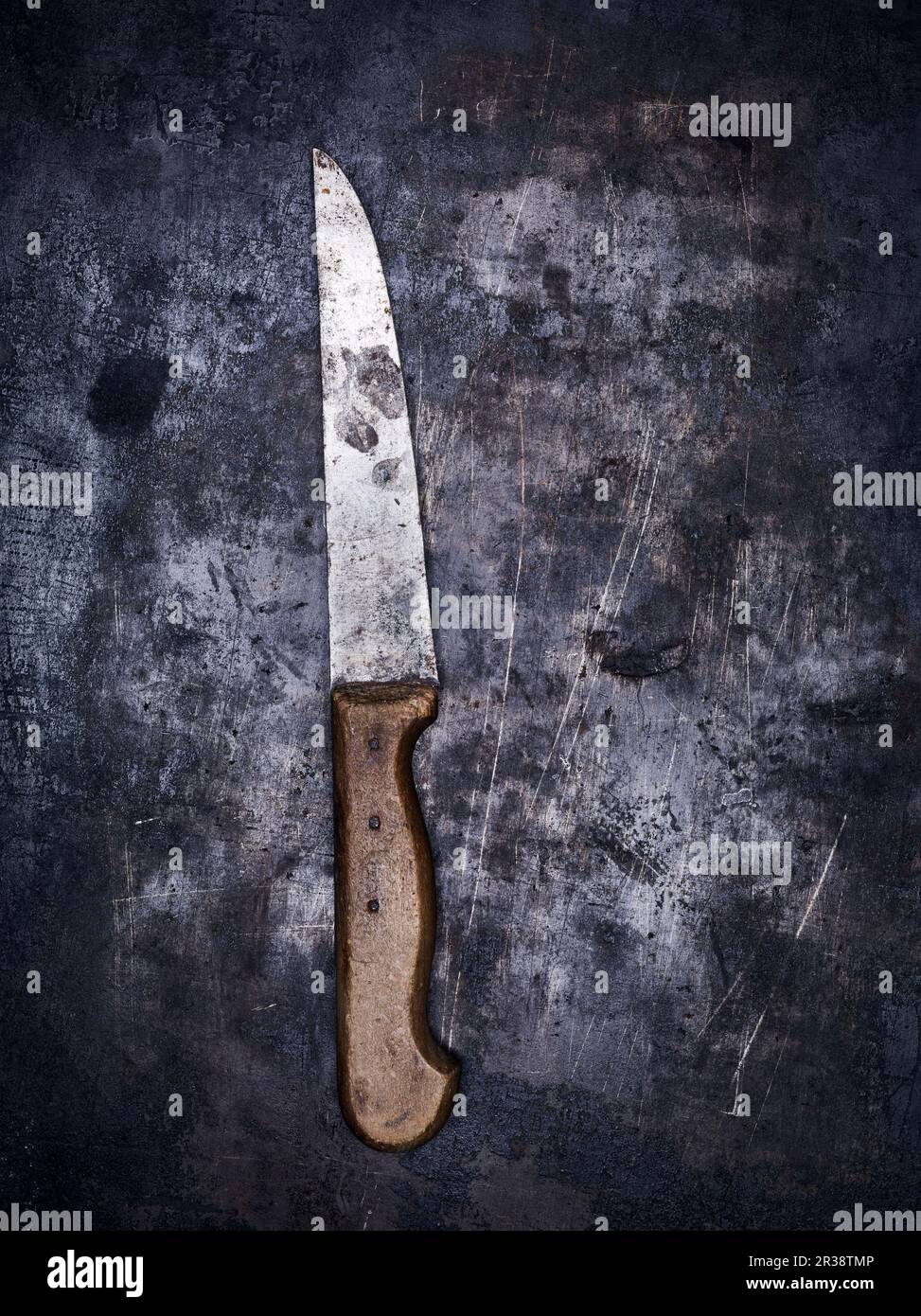 A vintage kitchen knife on a gray metal background (top view Stock ...
