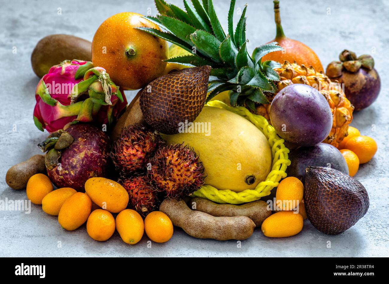 Exotic fruits on a concrete background Stock Photo - Alamy