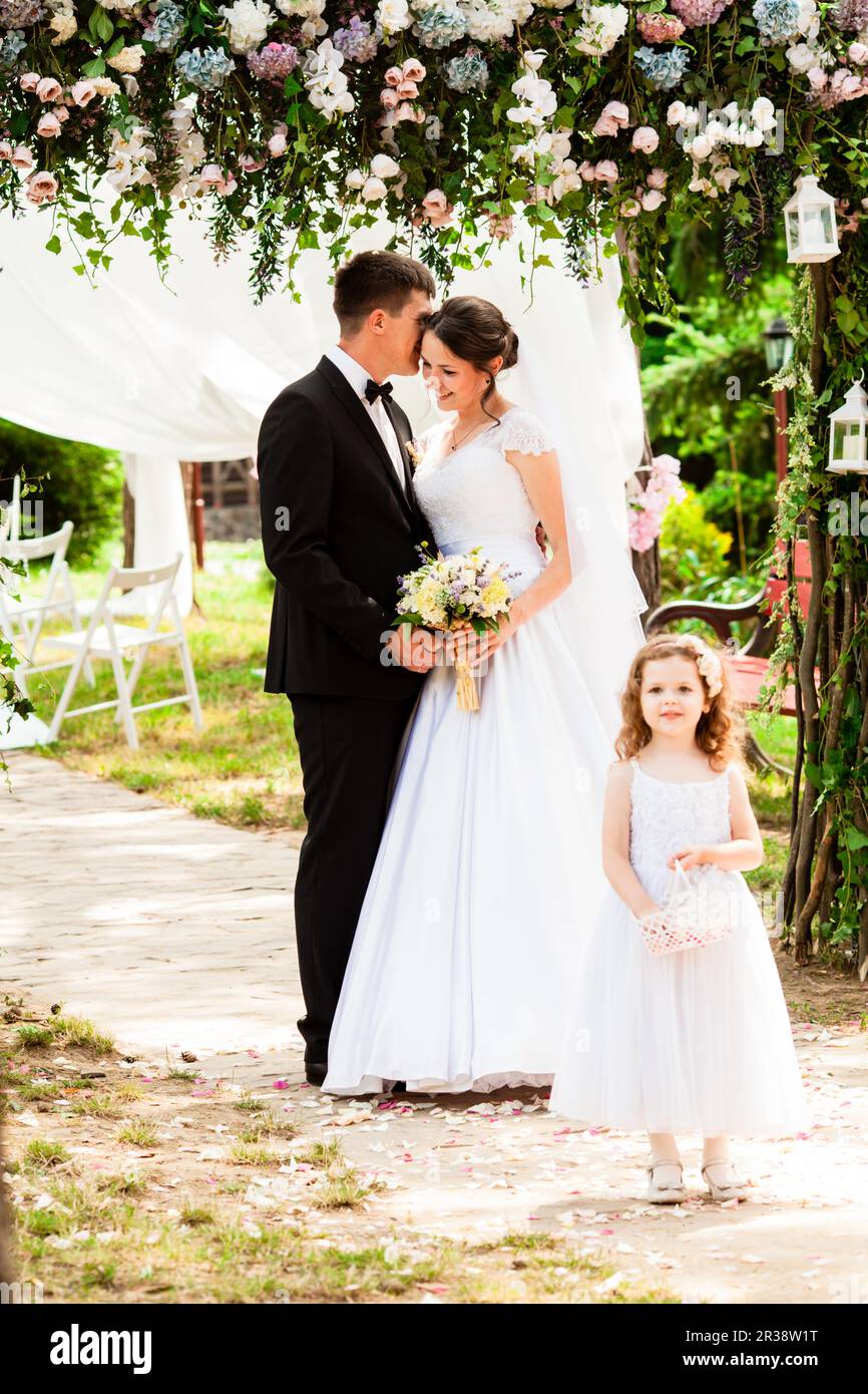 The little girl and wedding couple on ceremony Stock Photo - Alamy