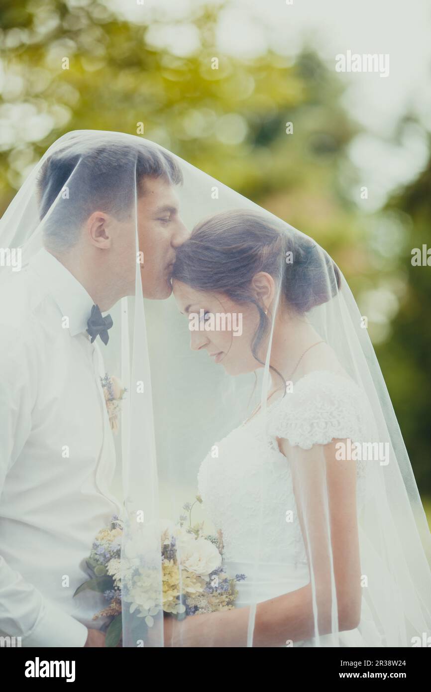 Young wedding couple under veil hi-res stock photography and images - Alamy