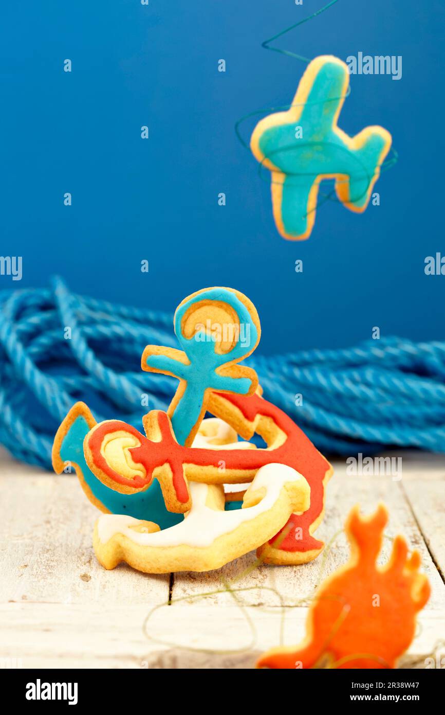 Colorful maritime biscuits in the form of anchors, airplanes and crabs ...