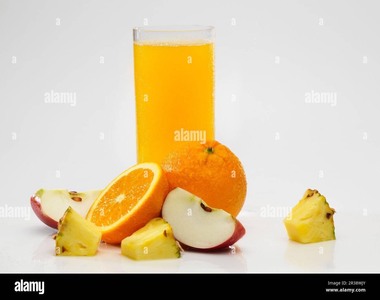 Pineapple, orange and apple juice in a glass Stock Photo - Alamy