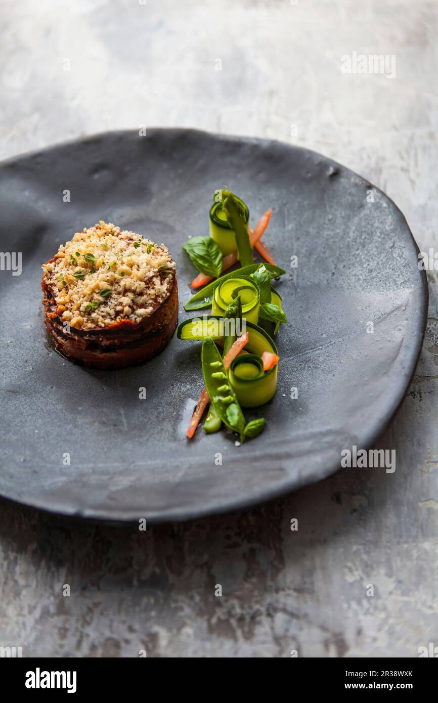 Vegan aubergine parmigiana with primaverde salad Stock Photo - Alamy