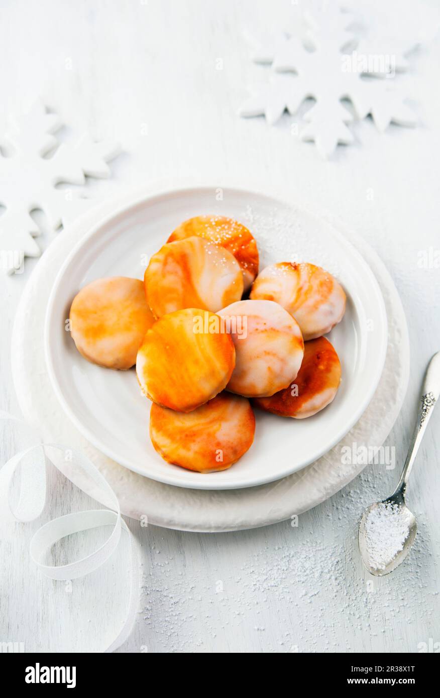 Orange biscuits with marbled orange icing Stock Photo - Alamy