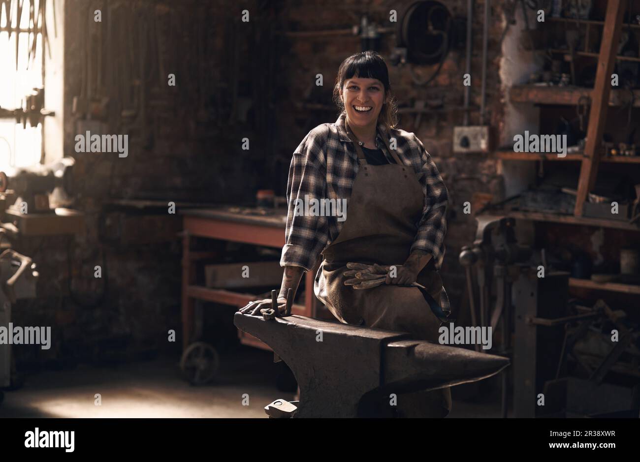 Foundry, blacksmith and portrait of woman with tools for industry ...