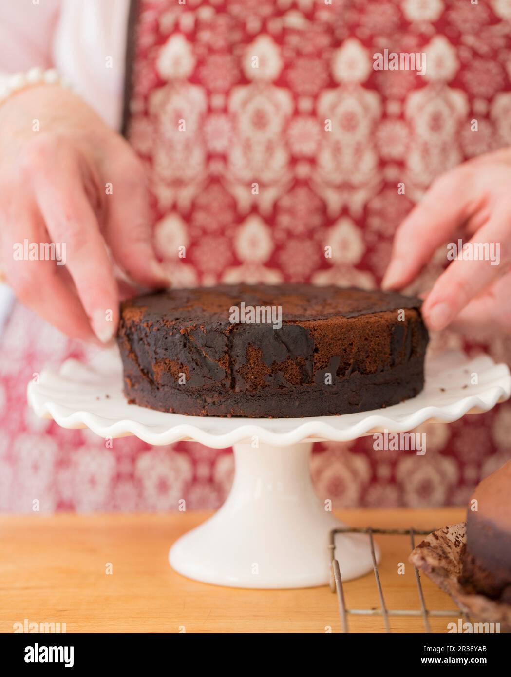 Decorating and finishing Devils Food Cake Stock Photo - Alamy