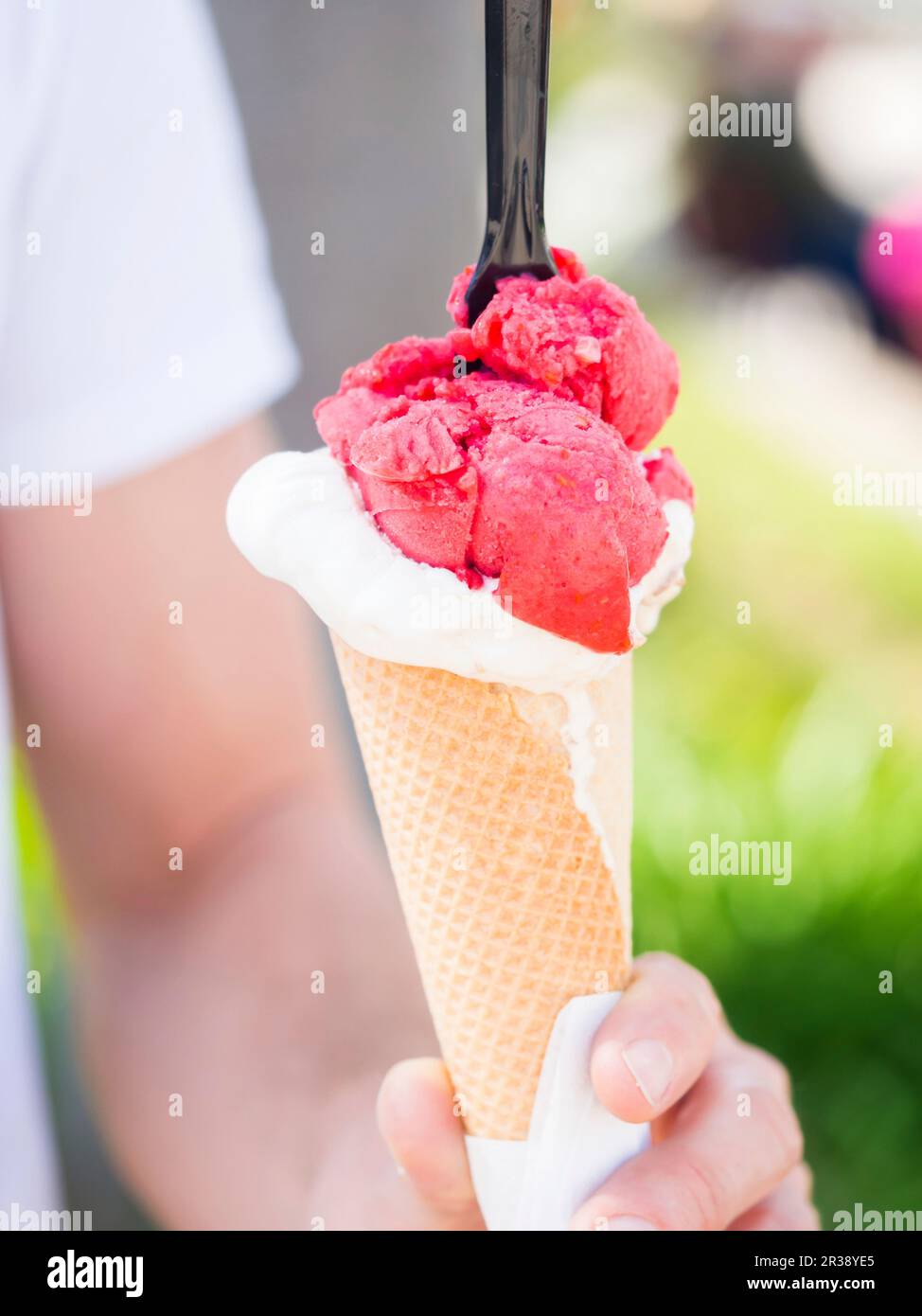 Raspberry and white chocolate ice cream in a cone Stock Photo - Alamy