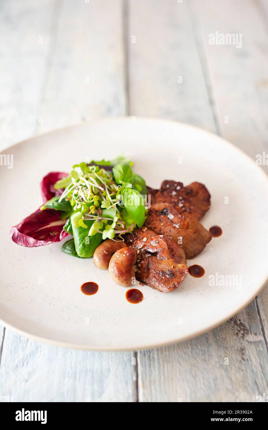 Rabbit liver and kidneys with salad Stock Photo - Alamy