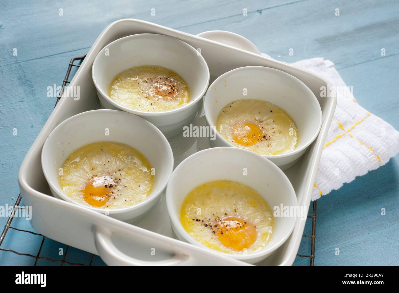 Baked eggs in ramekins Stock Photo - Alamy