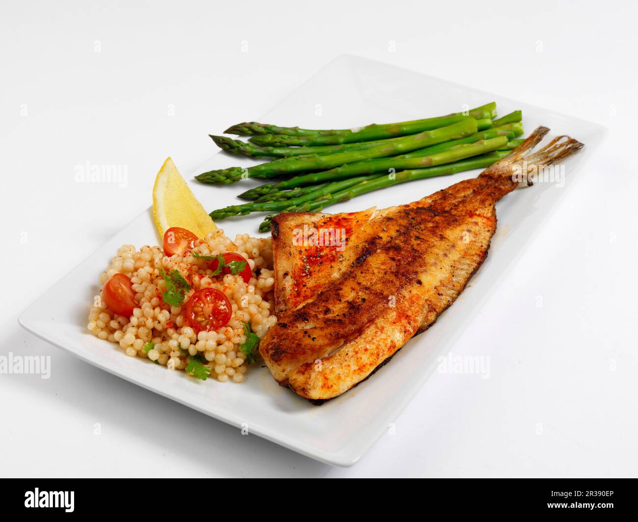 Fish with asparagus and couscous Stock Photo - Alamy