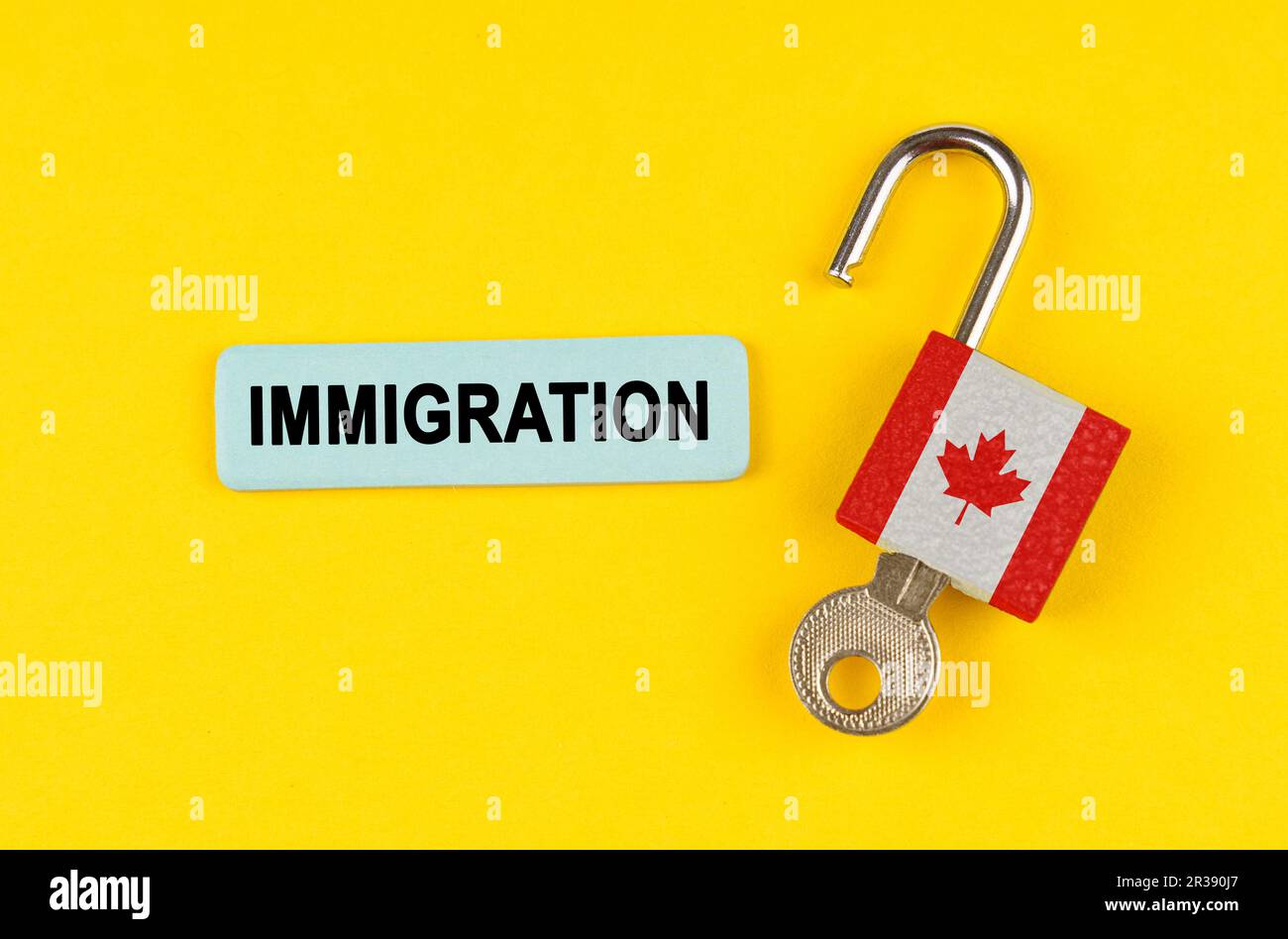On a yellow surface, an open lock with the image of the flag of Canada ...