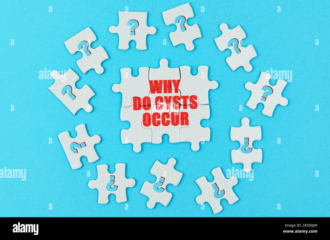 Medical concept. On a blue surface are puzzles with a question mark, in ...