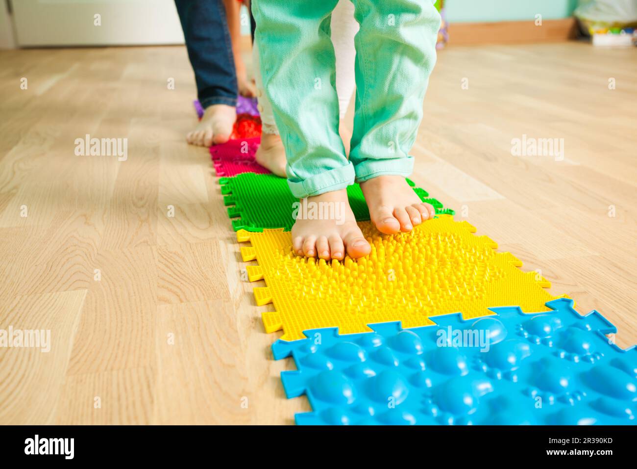 Closeup of kid feet while standing on special massaging mat Stock Photo ...