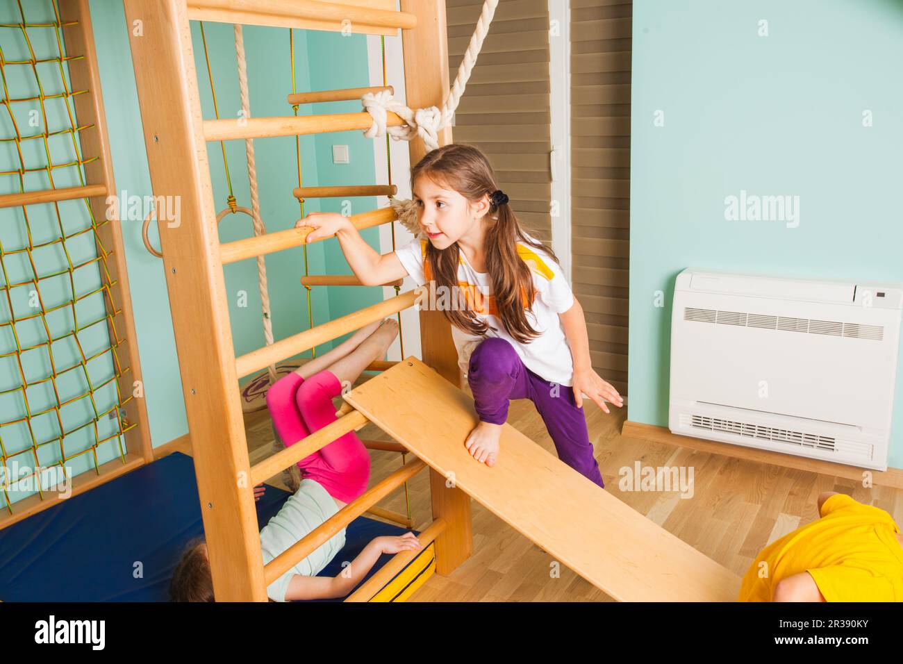 Children playing on a wooden sport complex Stock Photo - Alamy