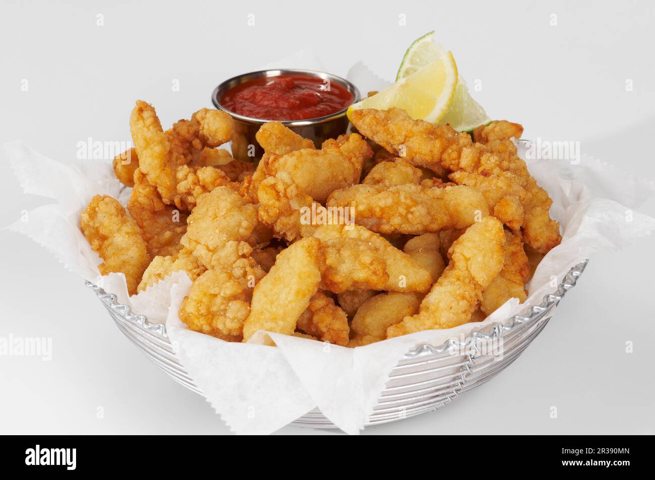 Fish in batter with ketchup and lemon Stock Photo - Alamy
