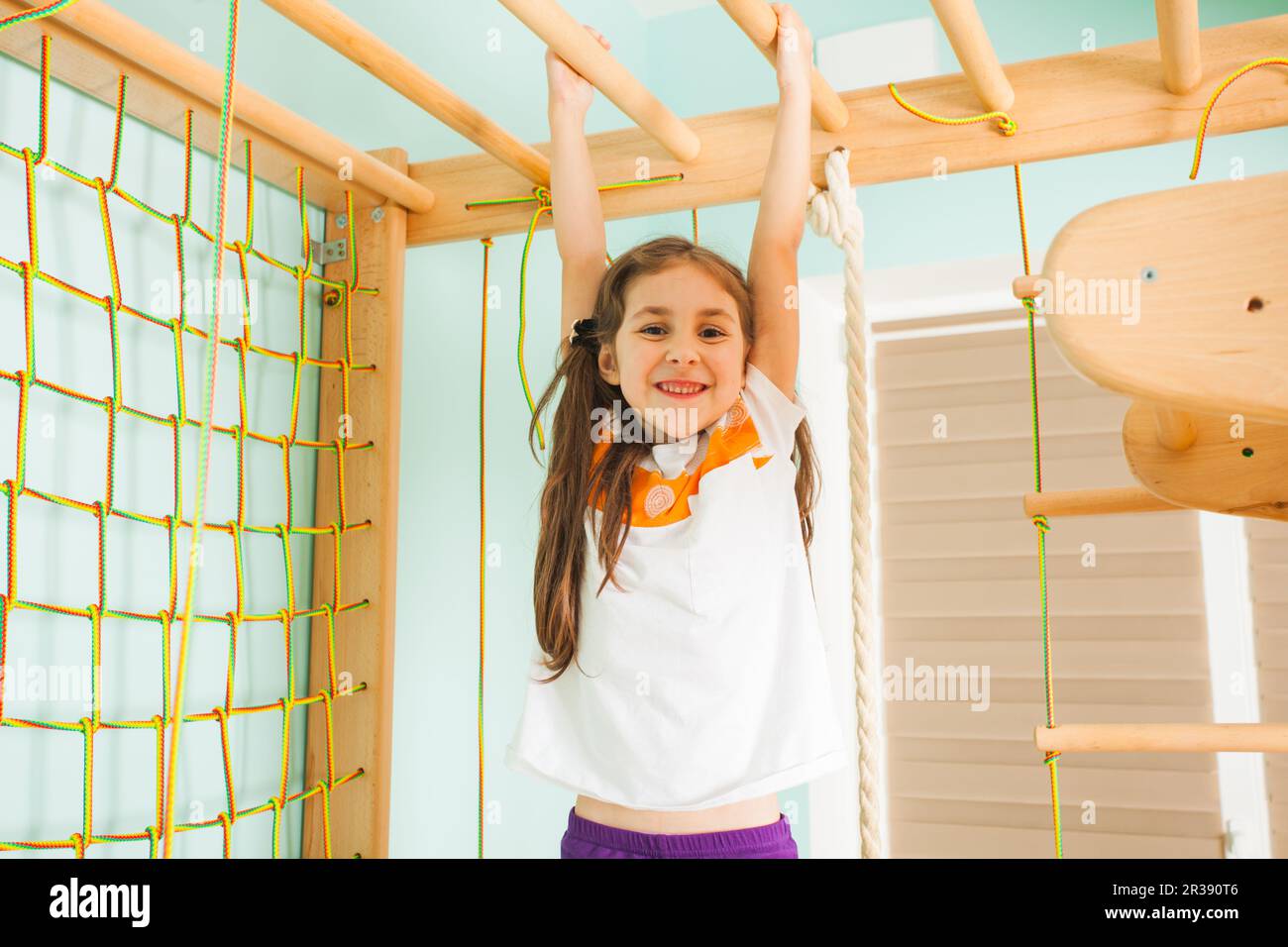 Girl plays sports on wall bars in her room Stock Photo - Alamy