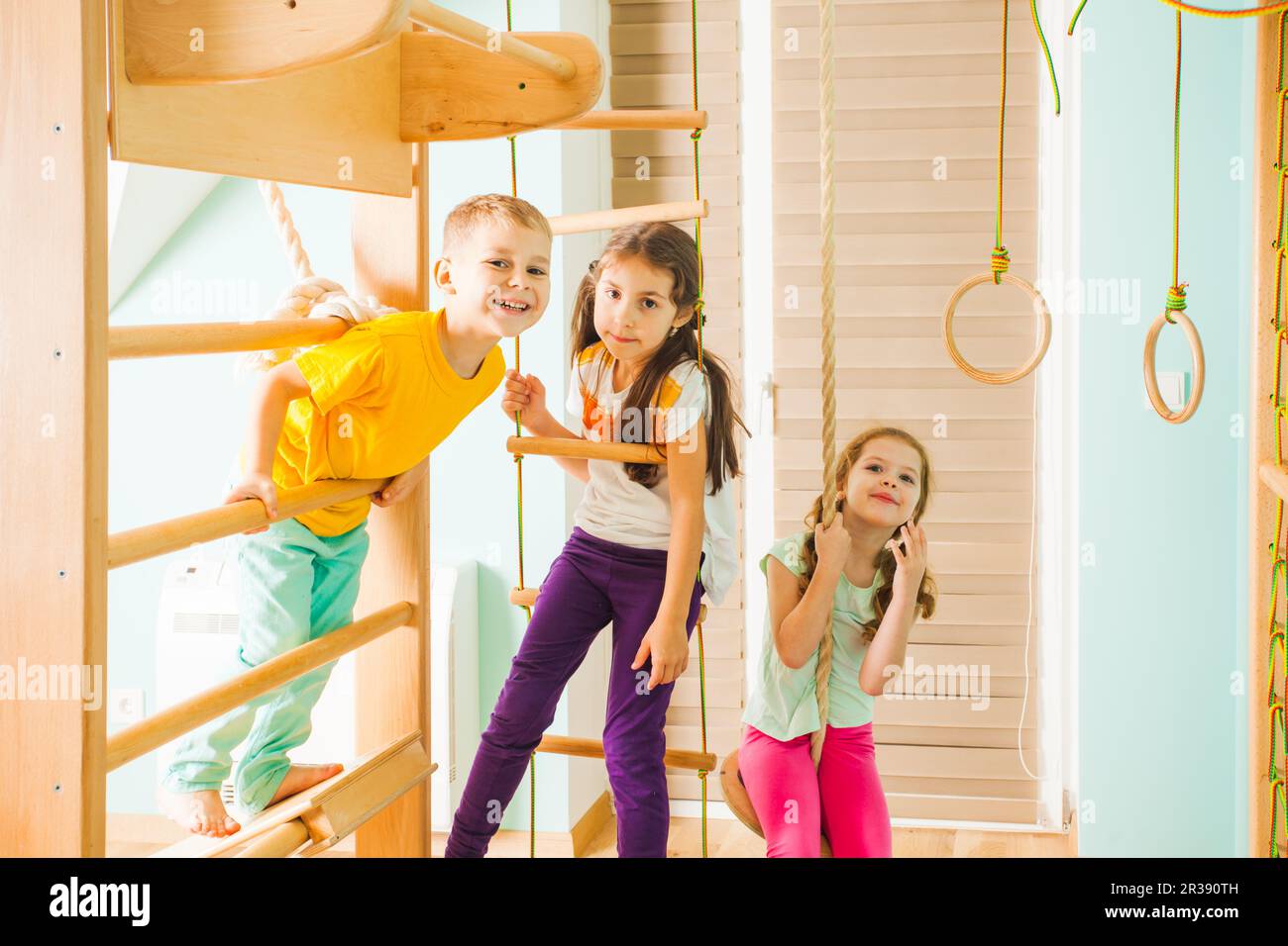 Portrait of smiling kids on a wooden ladder Stock Photo - Alamy