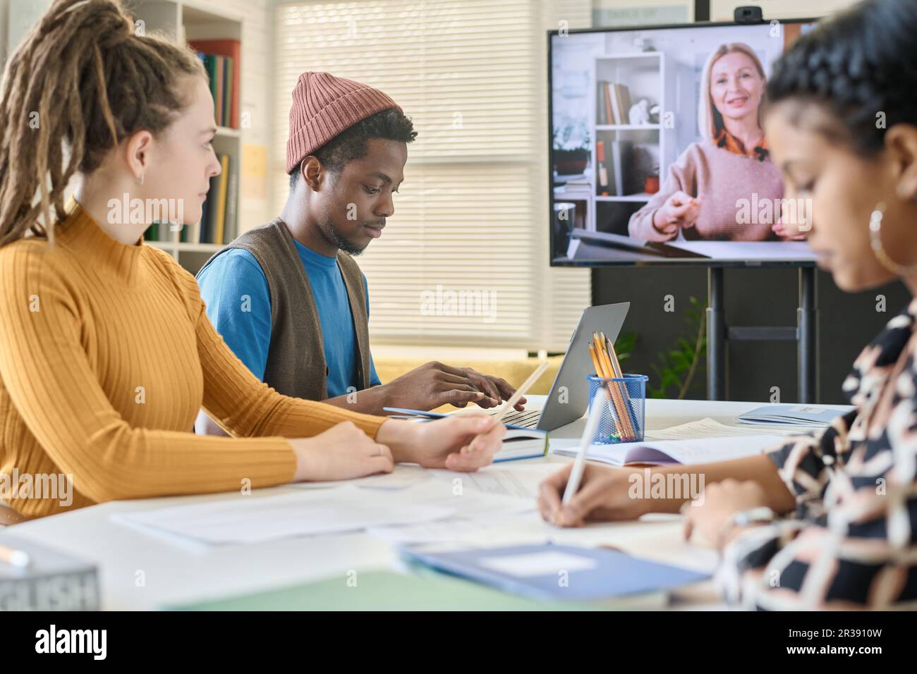 Group of students having online lesson with native speaker in foreign ...