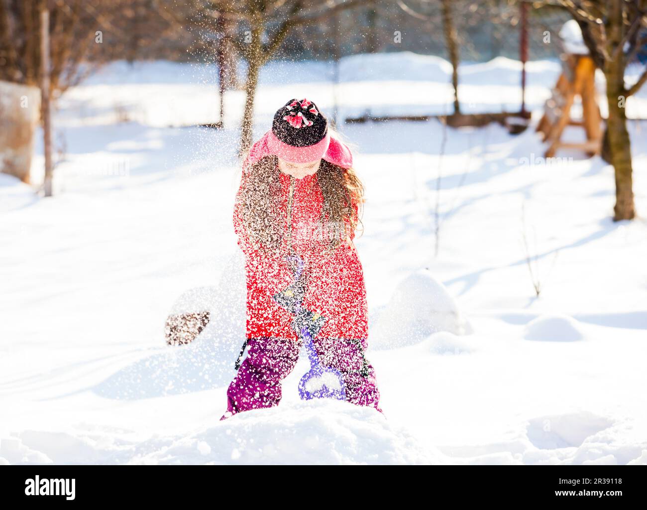 Little girl shoveling snow with shovel hi-res stock photography and ...