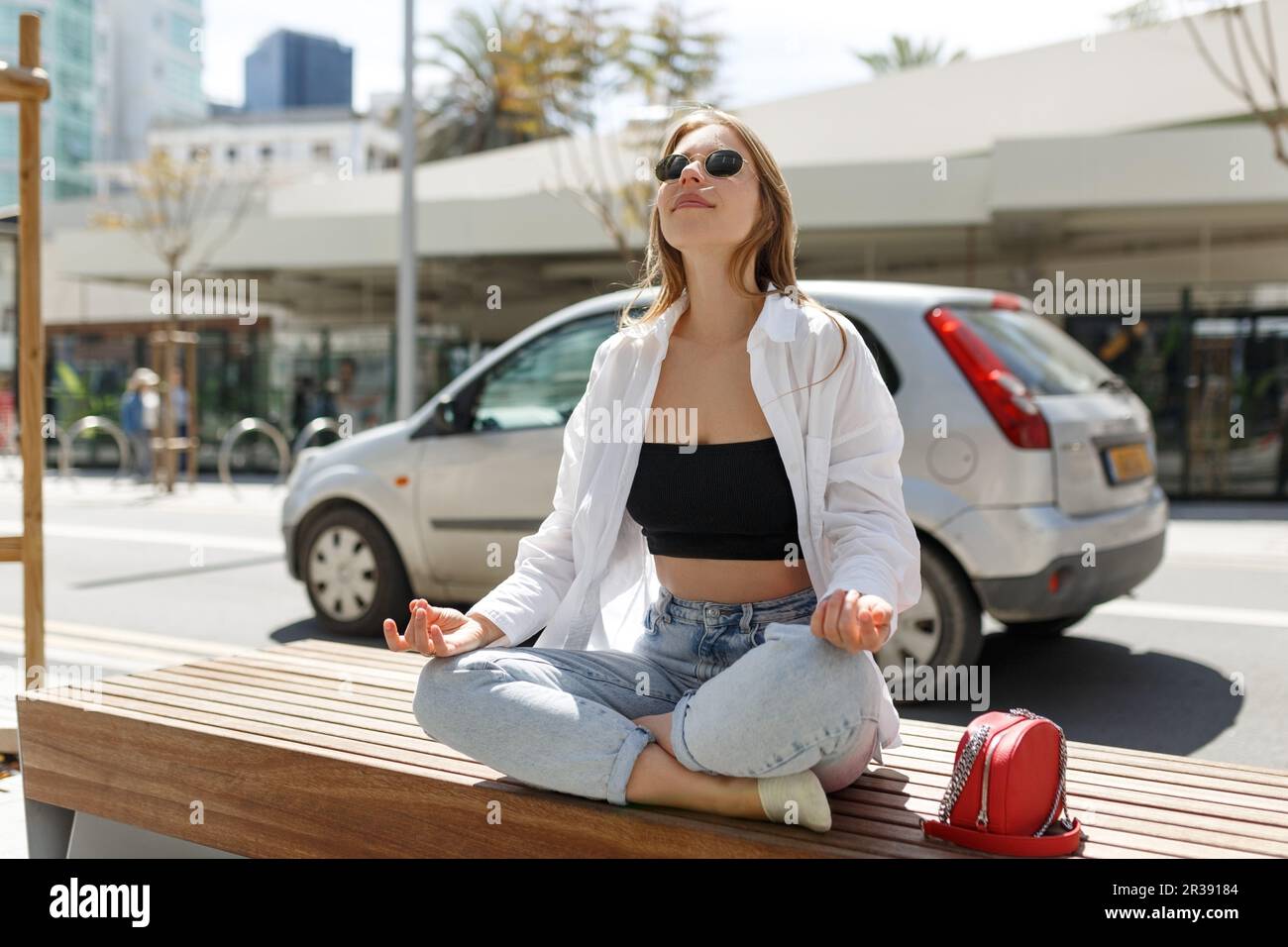 Beautiful young adult woman meditating sitting crossed leg lotus pose ...