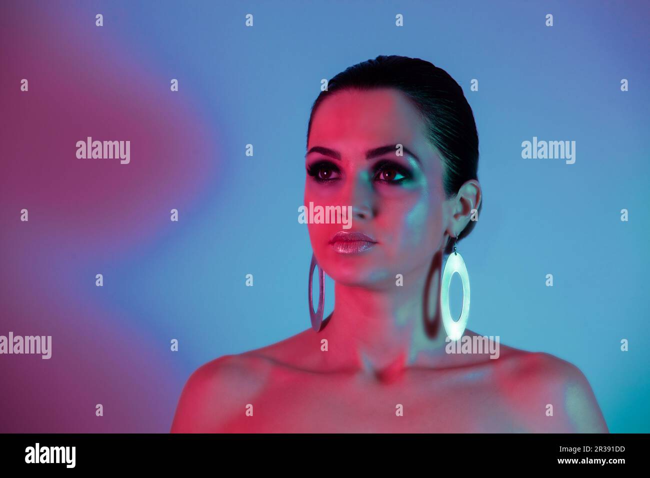 Fashion model under the neon pink and blue light Stock Photo - Alamy