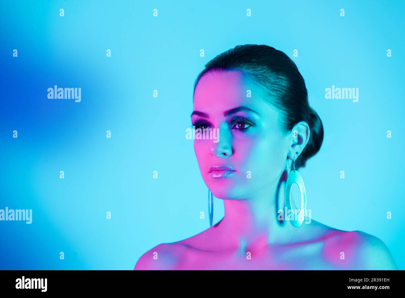 Fashion model under the neon pink and blue light Stock Photo - Alamy