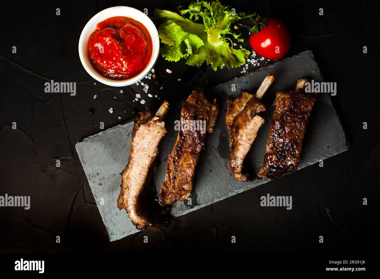 Grilled sliced barbecue pork ribs with sauce Stock Photo - Alamy
