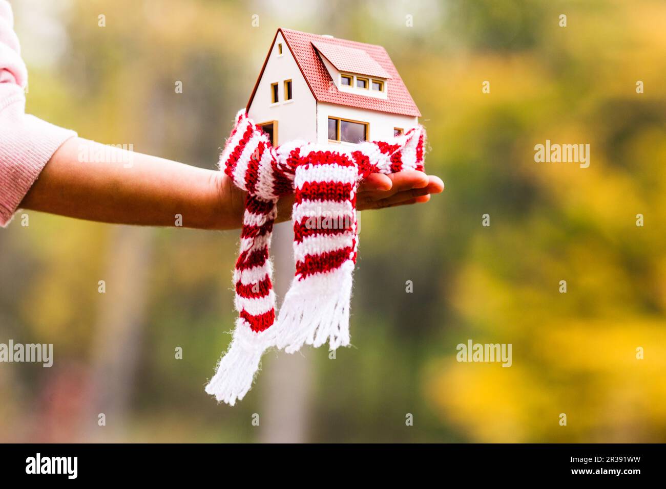 Warm in the house concept, dressed building Stock Photo - Alamy