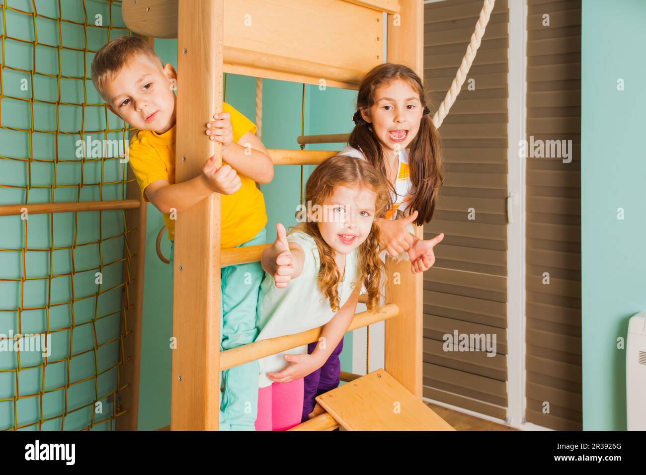 Portrait of smiling kids on a wooden ladder Stock Photo - Alamy