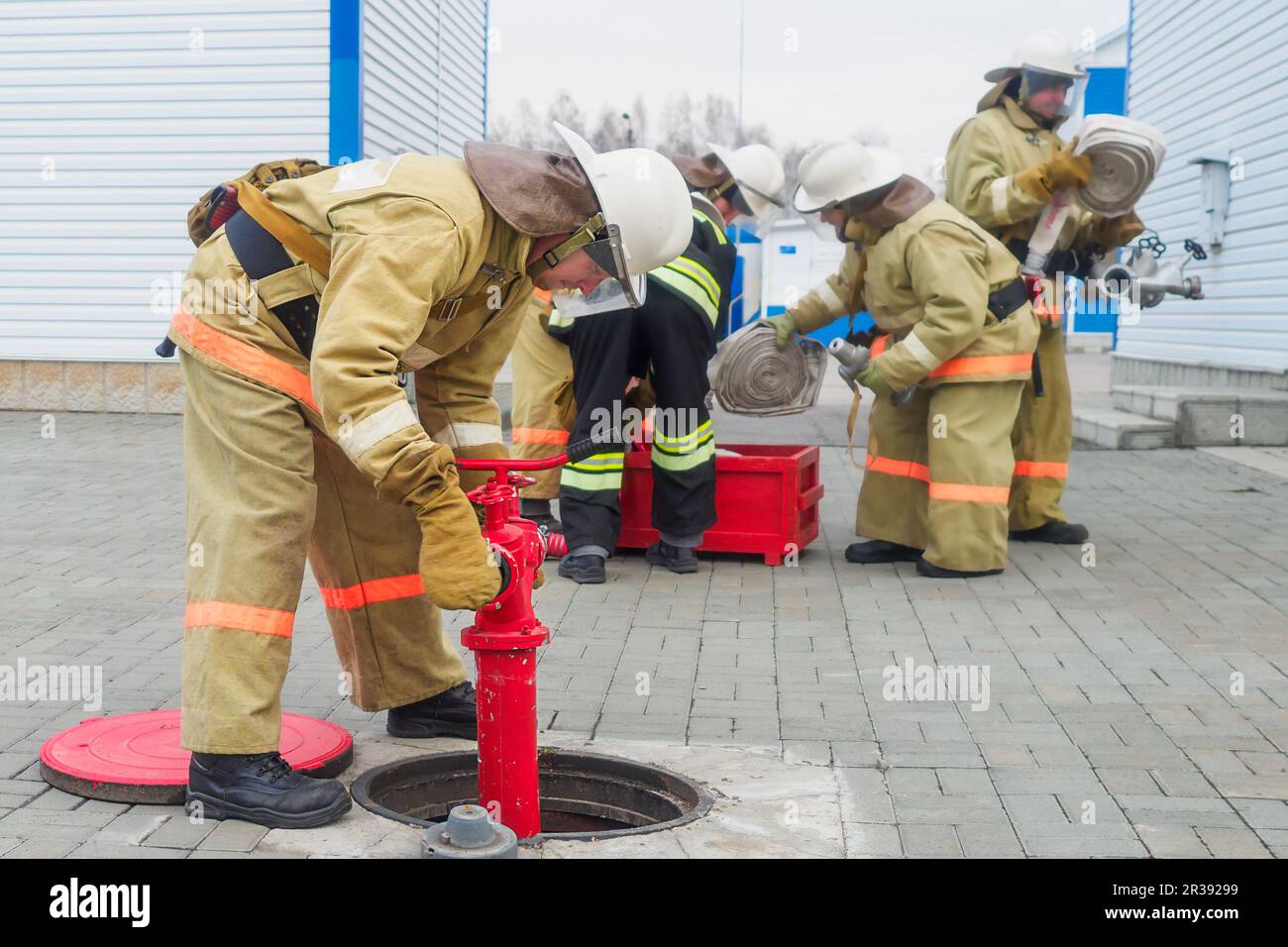 Fire brigade deploys equipment outside in open air and connects fire ...