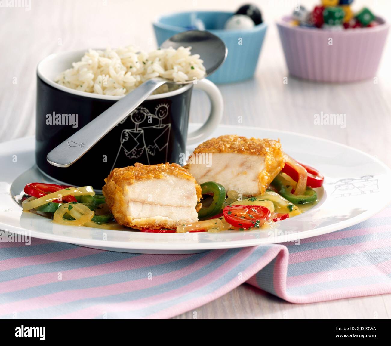 Baked coalfish with a cornflake coating served with vegetables and rice ...
